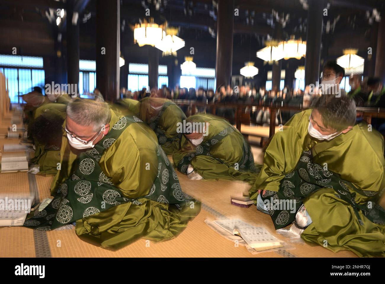 Monks moving their bodies in all directions chant a Buddhist sutra ...