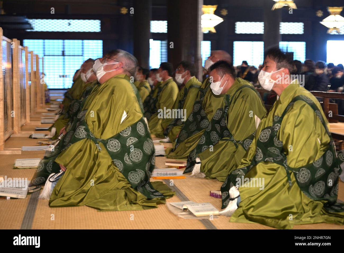 Monks moving their bodies in all directions chant a Buddhist sutra ...