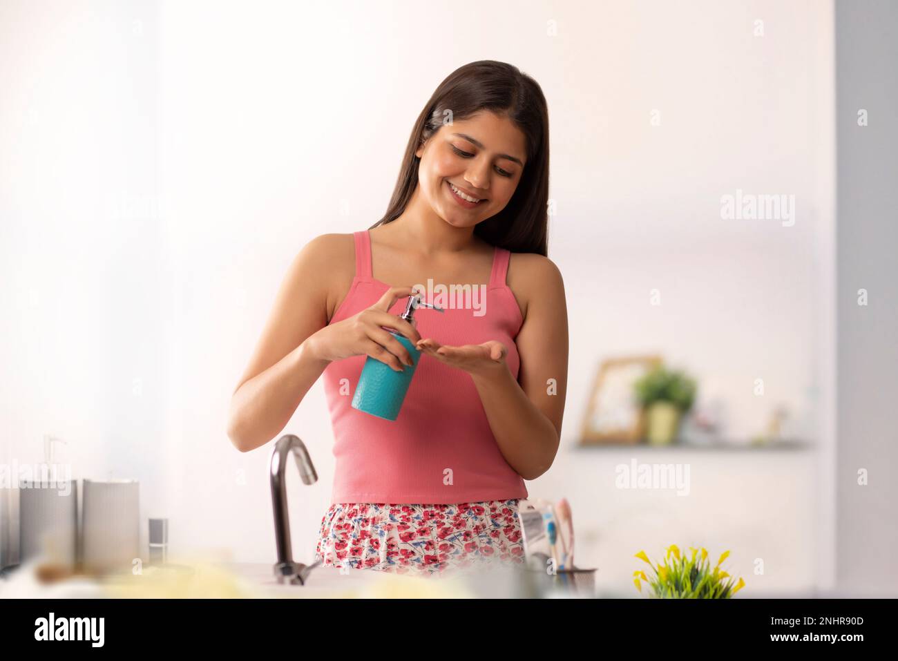 Woman cleaning her hands with liquid hand wash in bathroom Stock Photo ...