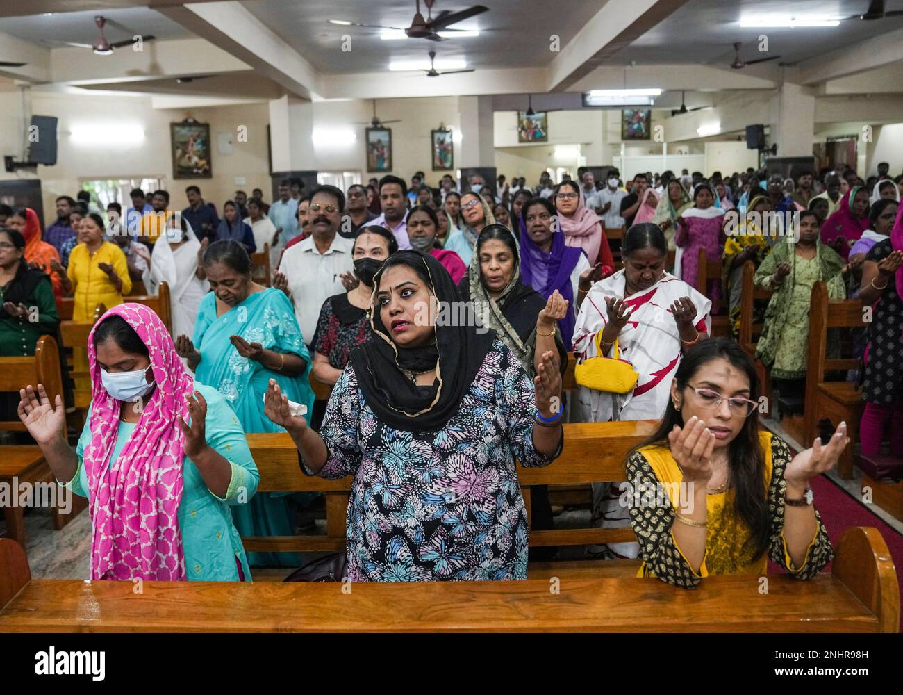 Catholics offer prayers during a mass in observance of Ash Wednesday at ...