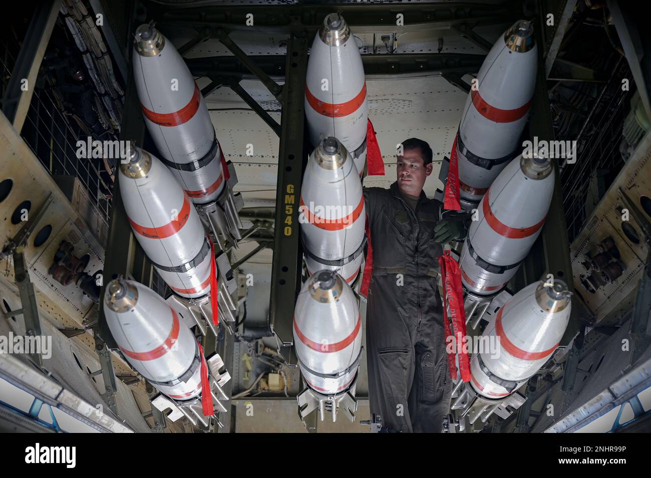 Capt. Jonathan Acker, 20th Bomb Squadron navigator, inspects a MK-62 ...