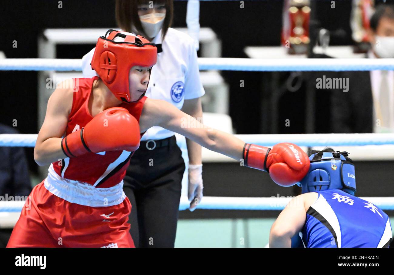Japanese boxer Sena Irie (red) delivers a punch during the women's featherweight final match of ...
