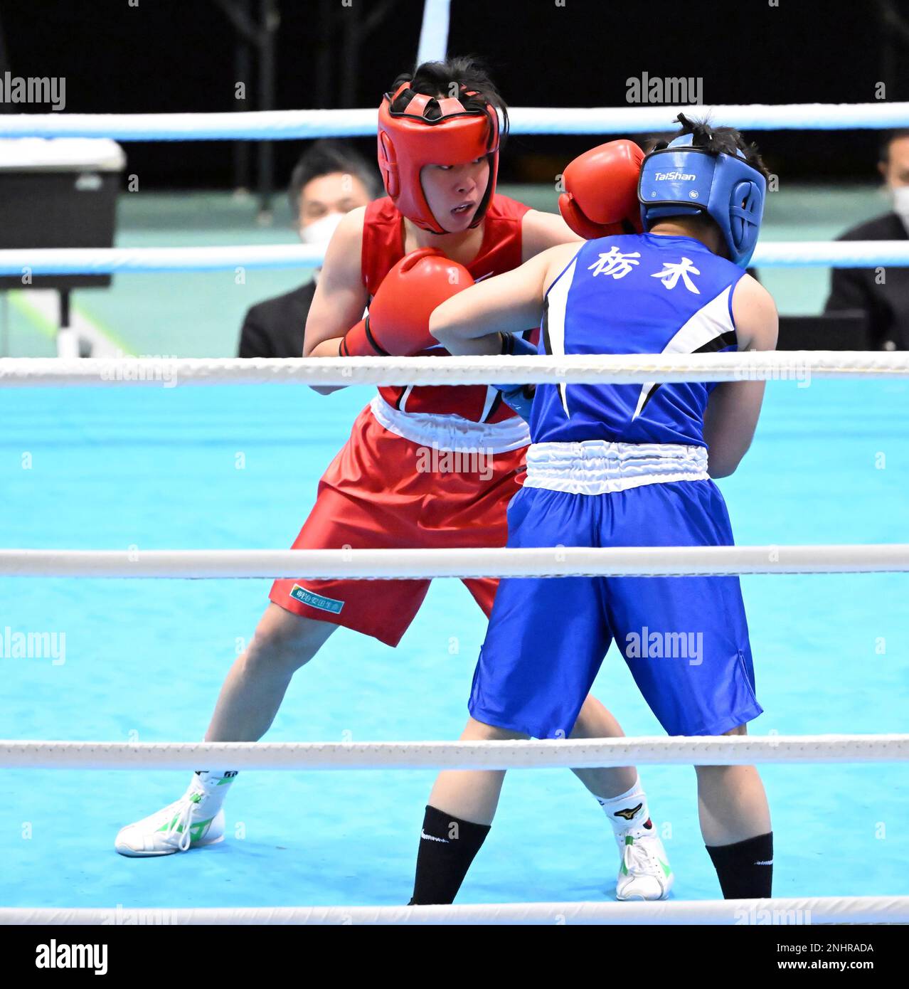 Japanese boxer Sena Irie (red) delivers a punch during the women's featherweight final match of ...