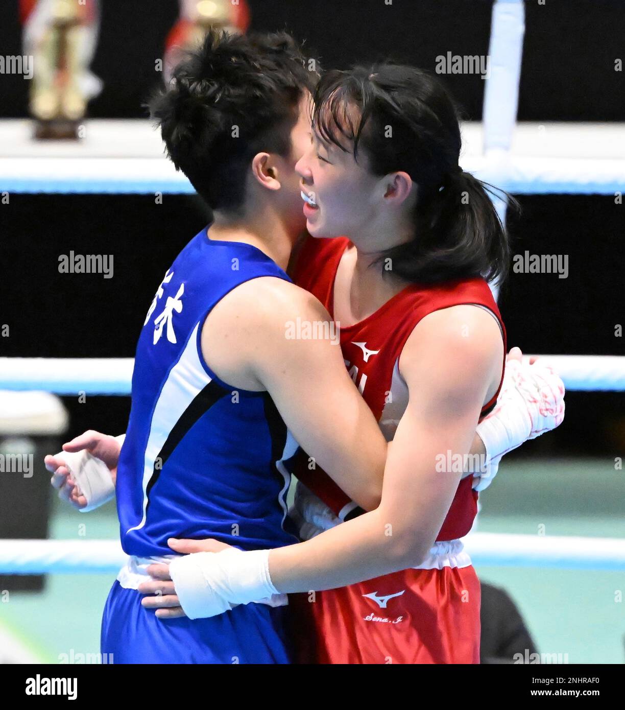 Japanese boxer Sena Irie (red) reacts after winning the women's featherweight final match of ...