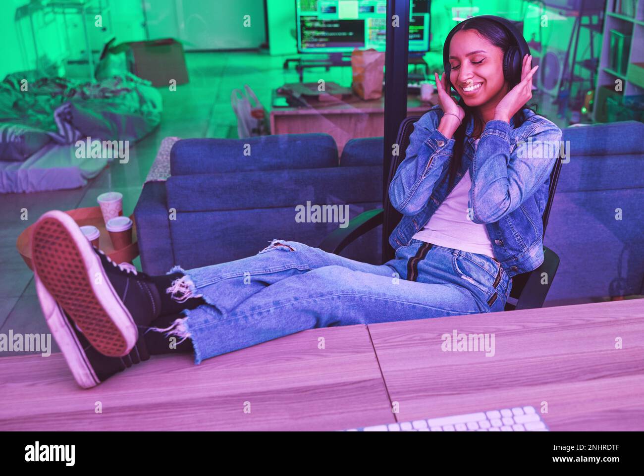 Programmer, headphones or relax in neon house after technology coding ...