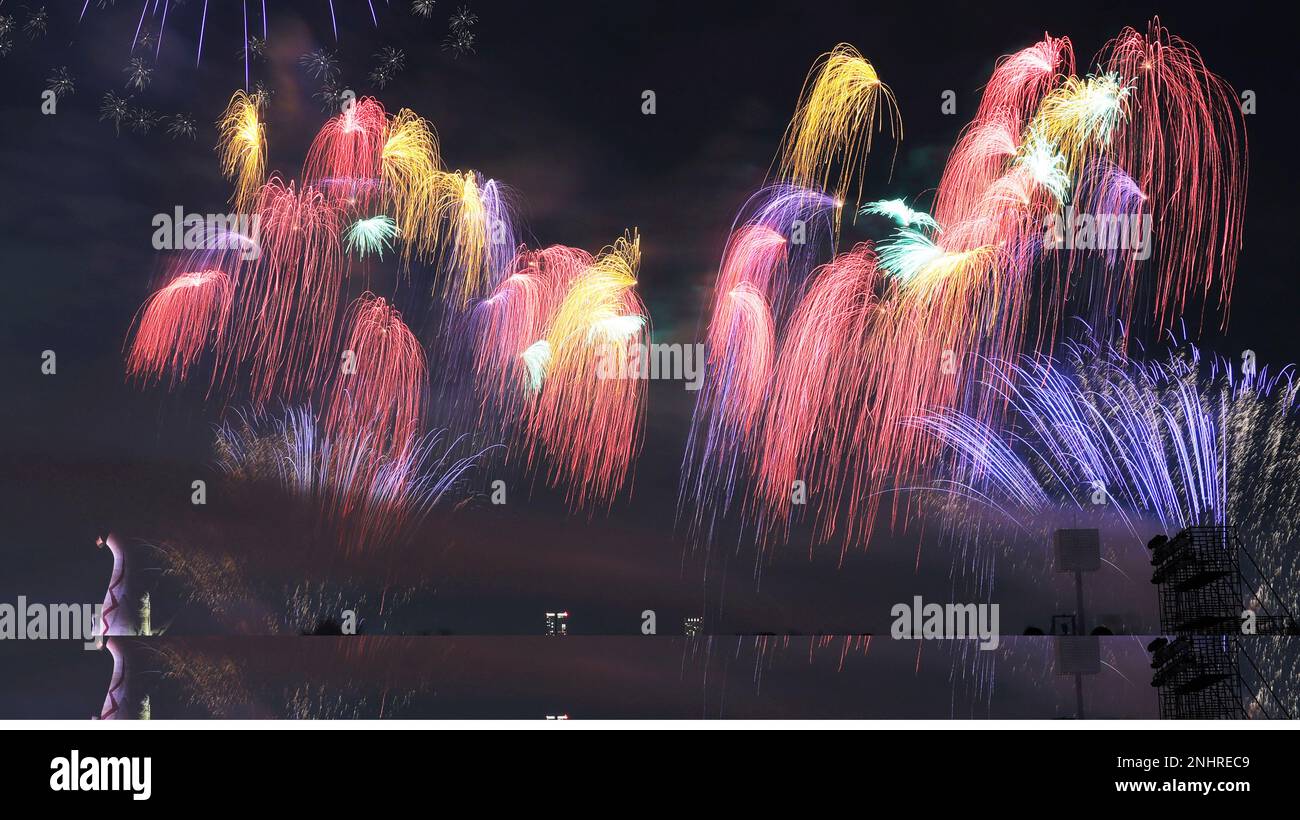 Artistic fireworks illuminate blossoms in the night sky over the Expo ...
