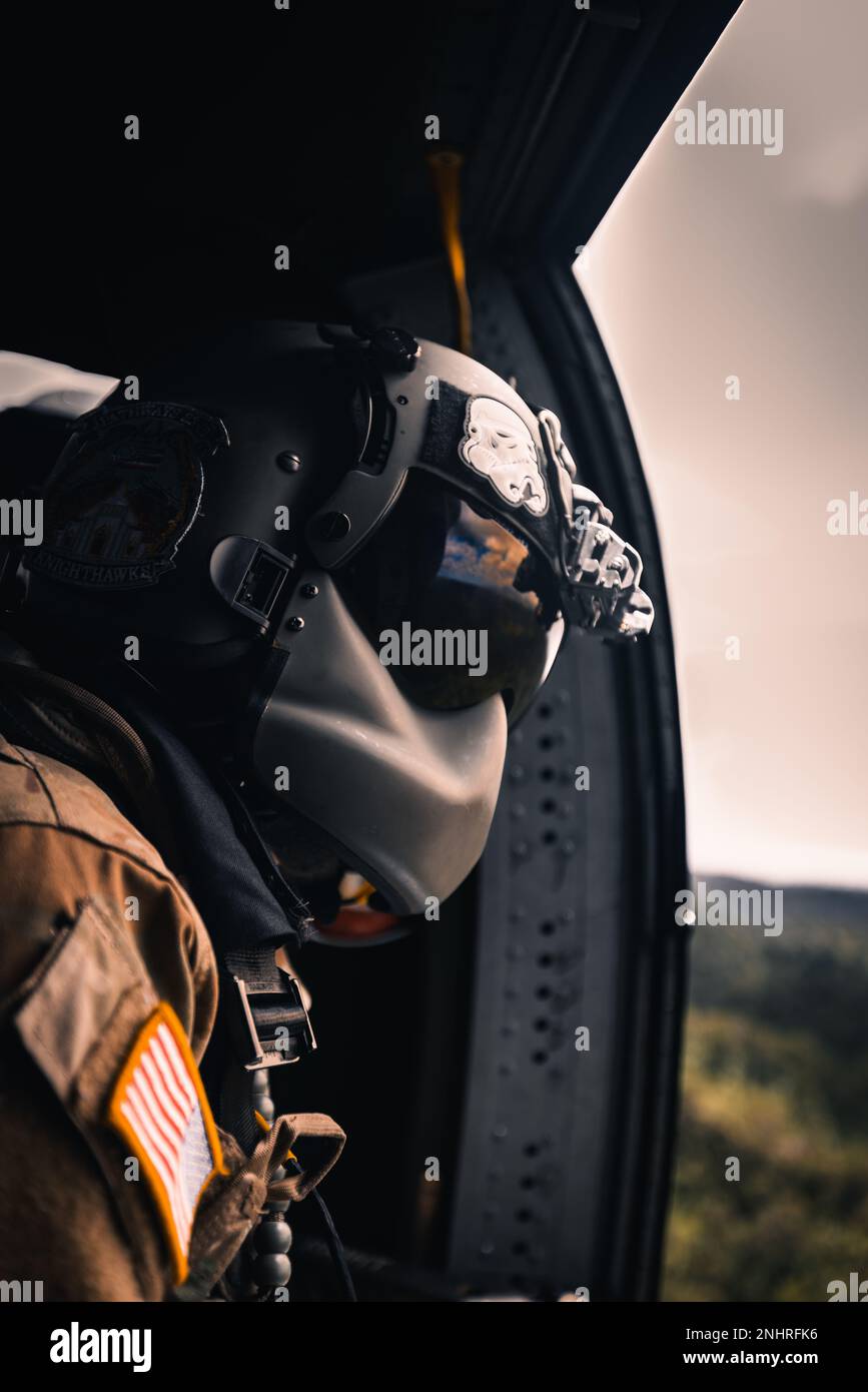 U.S. Soldier performs his duty of being the Crew Chief aboard a UH-60 ...