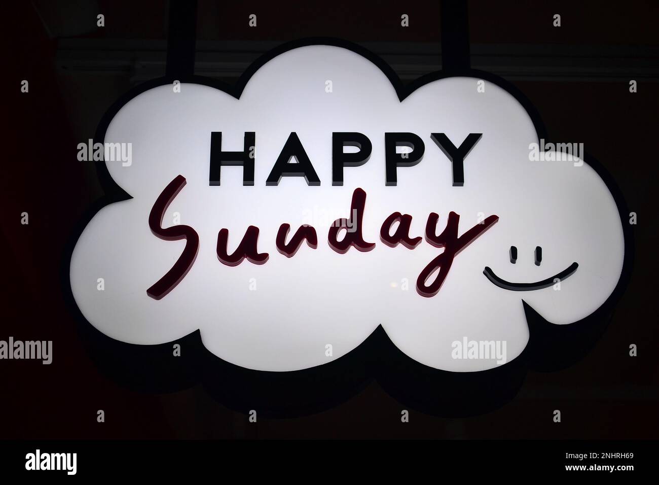 A sign says 'HAPPY Sunday with a smile emoticon in a white message box ...