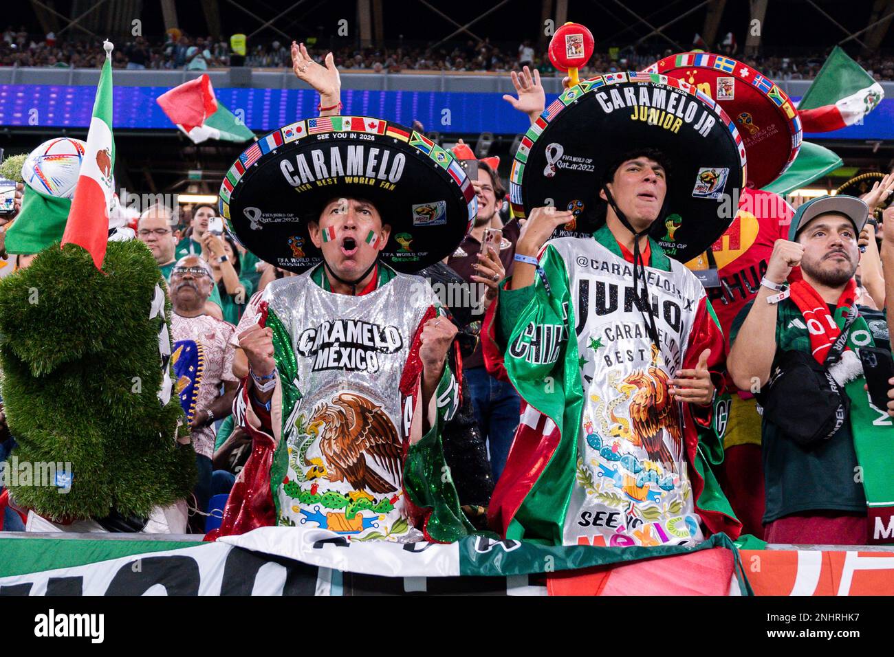 DOHA, QATAR - NOVEMBER 22: Fans draped in custom Mexican flags and ...