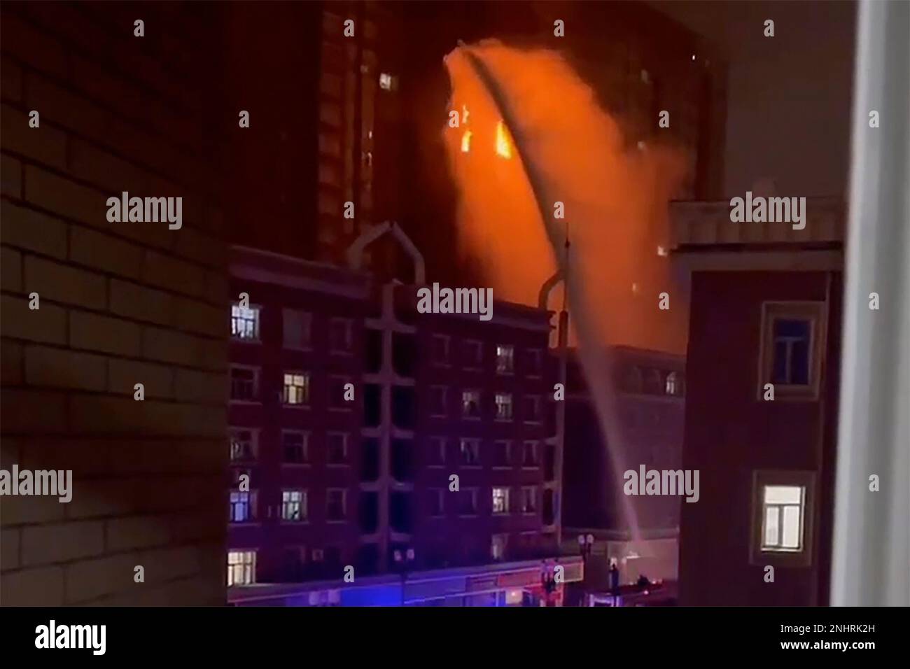 In this image taken from video, firefighters spray water on a fire at a ...