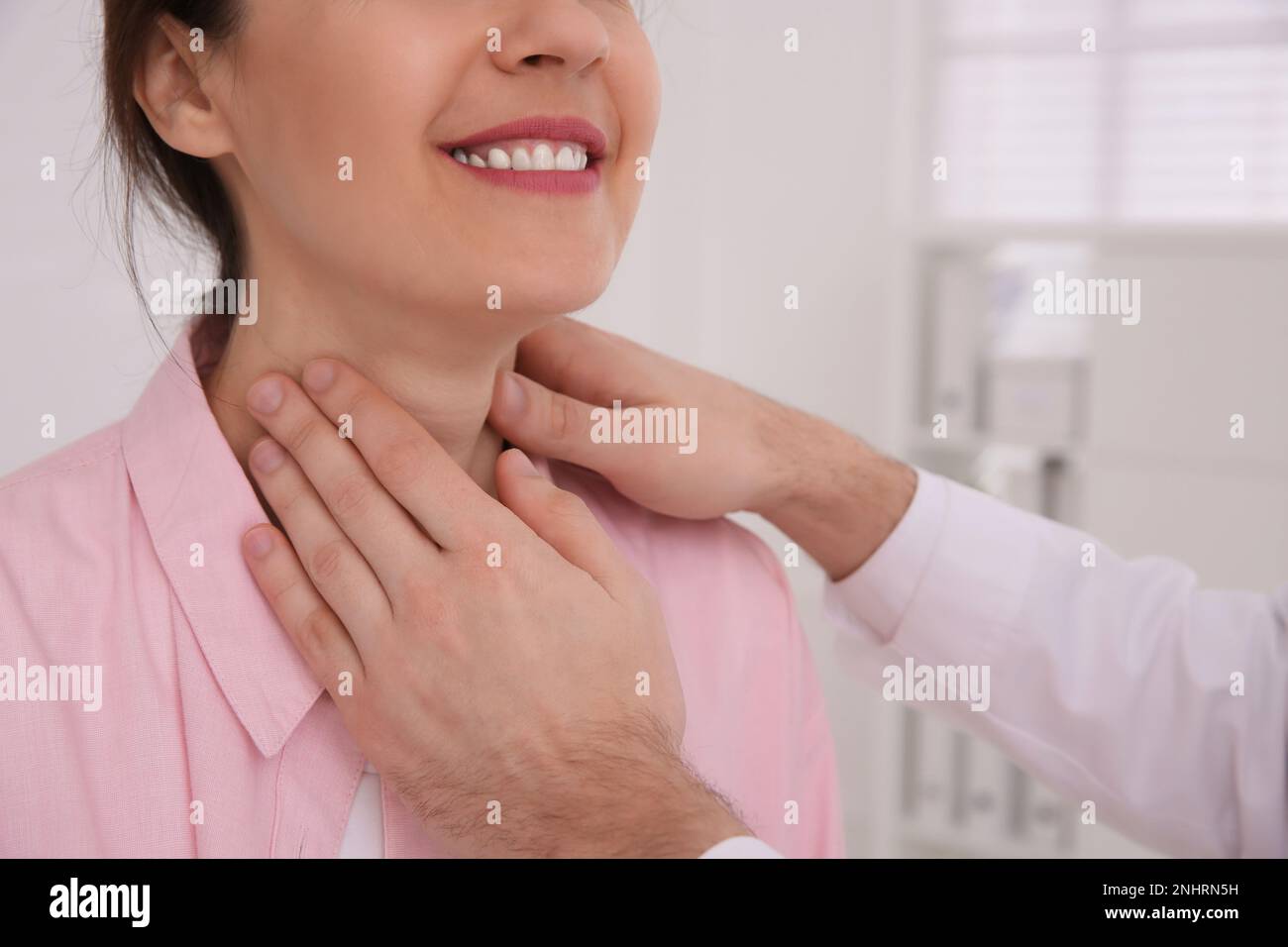 Doctor examining thyroid gland of patient indoors, closeup Stock Photo ...