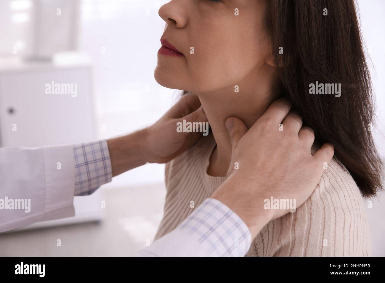 Doctor examining thyroid gland of patient in hospital, closeup Stock ...