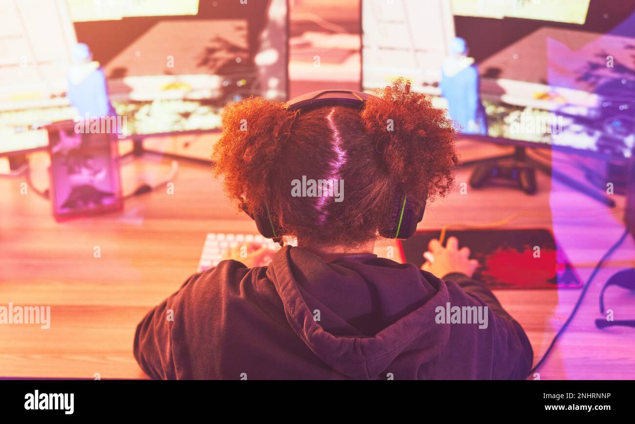 Back of girl, streamer and video game on computer in home, desk or ...