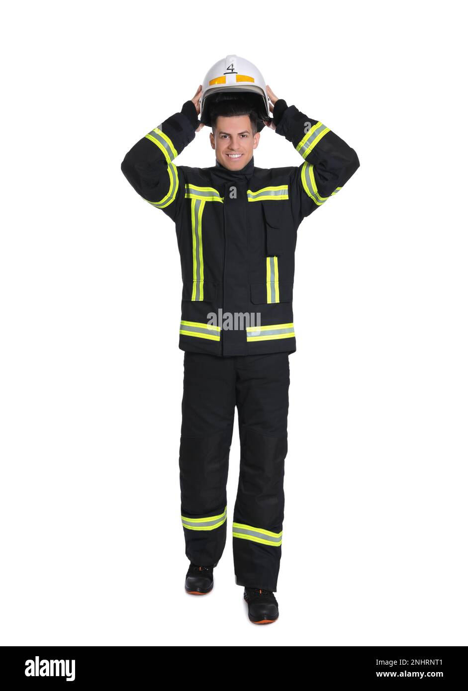 Full length portrait of firefighter in uniform wearing helmet on white ...