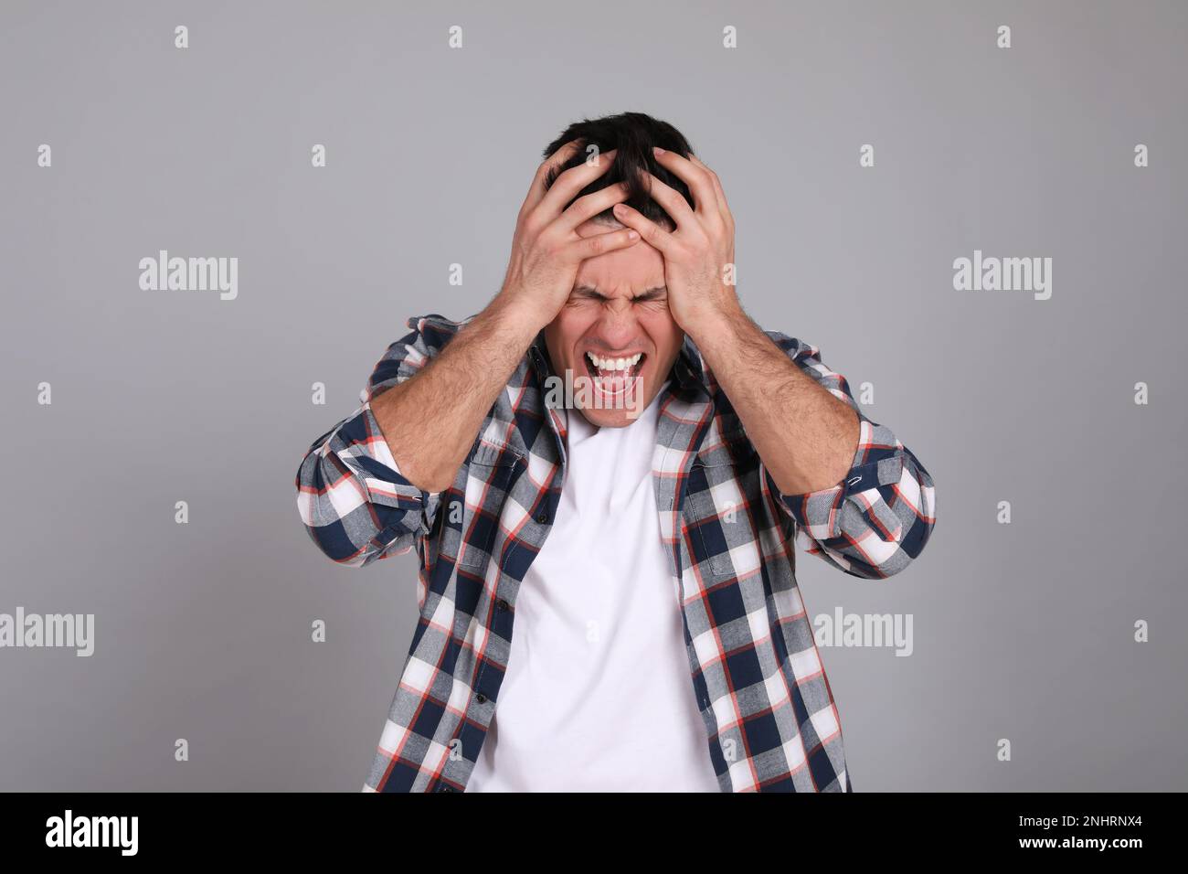 Portrait of emotional man on light grey background. Personality concept ...