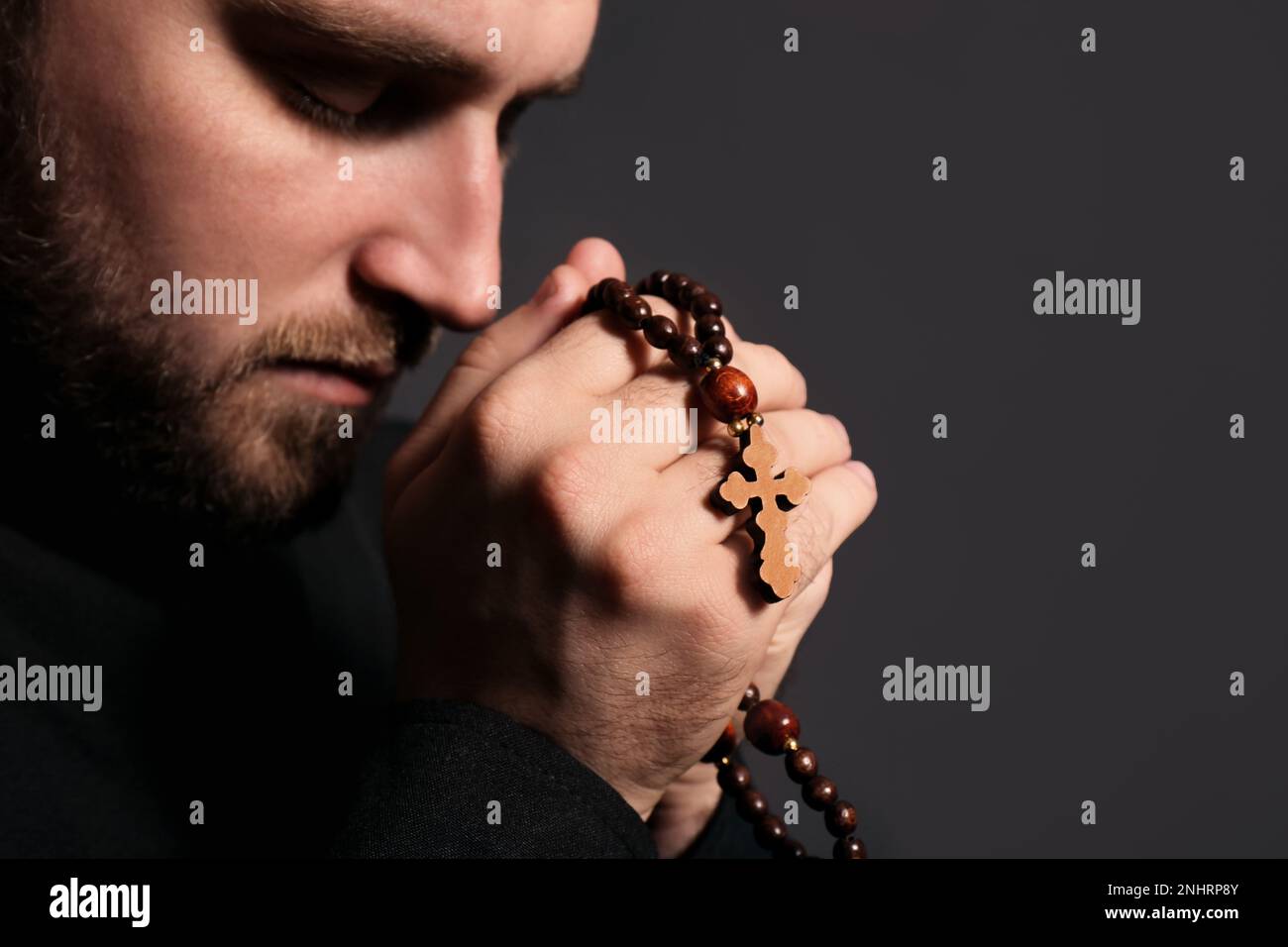 Praying hands rosary on black hi-res stock photography and images - Alamy