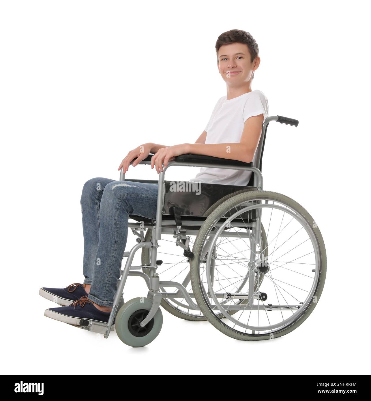 Teen boy in wheelchair on white background Stock Photo - Alamy
