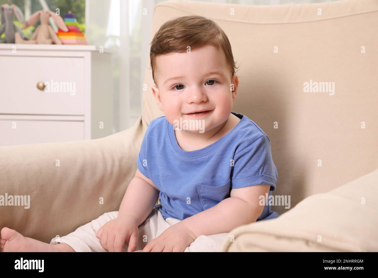 Little baby sitting in armchair hi-res stock photography and images - Alamy