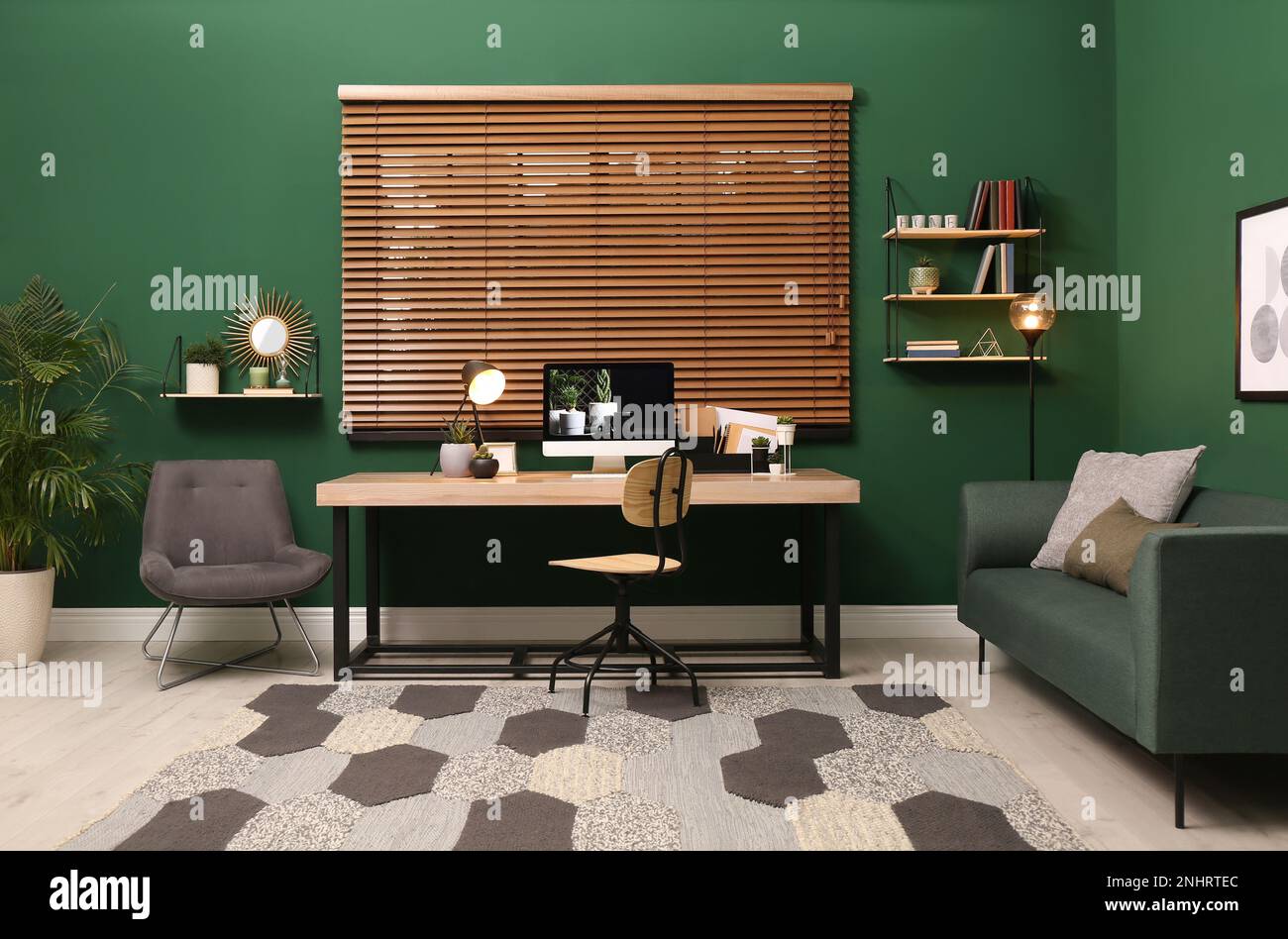 Comfortable workplace with modern computer near window in room ...