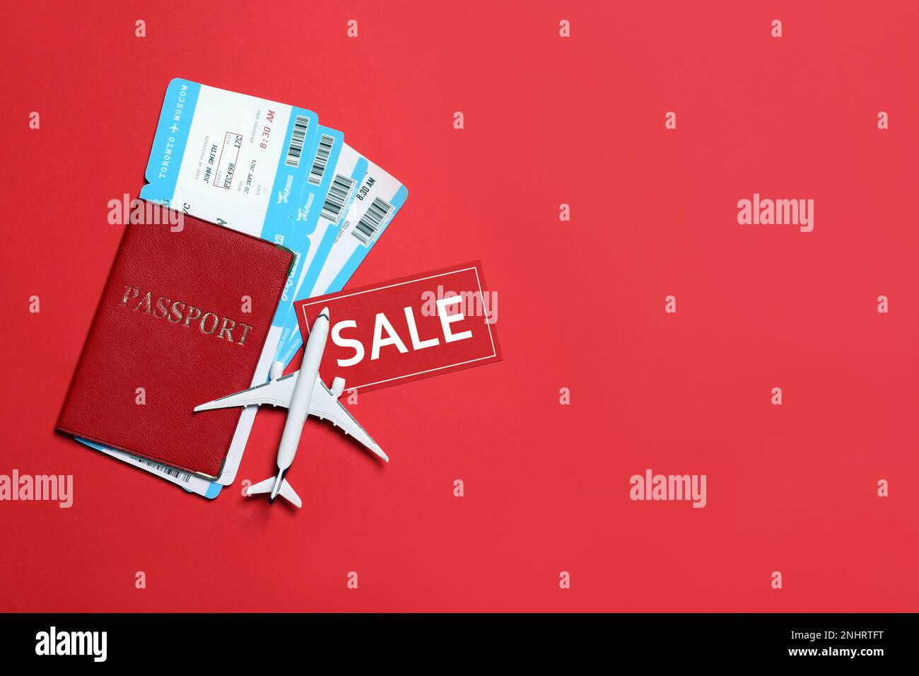 Flight tickets, passport, plane model and SALE card on red background ...