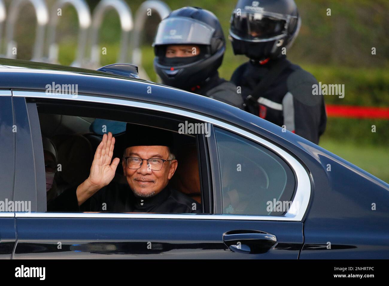 Malaysia's newly appointed Prime Minister Anwar Ibrahim waves from his ...