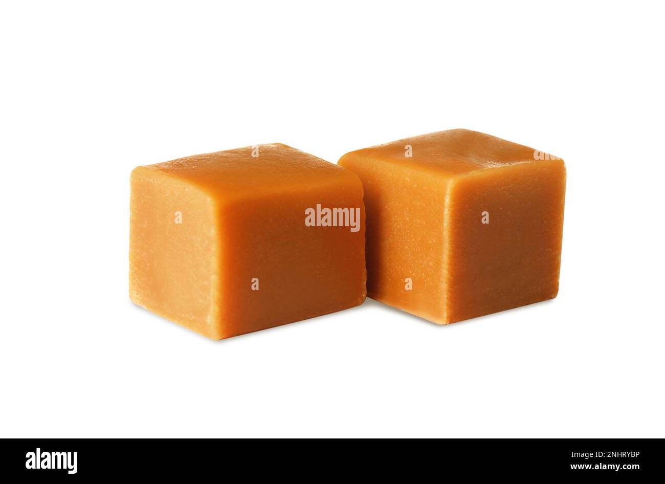 Two sweet caramel candies on white background Stock Photo - Alamy
