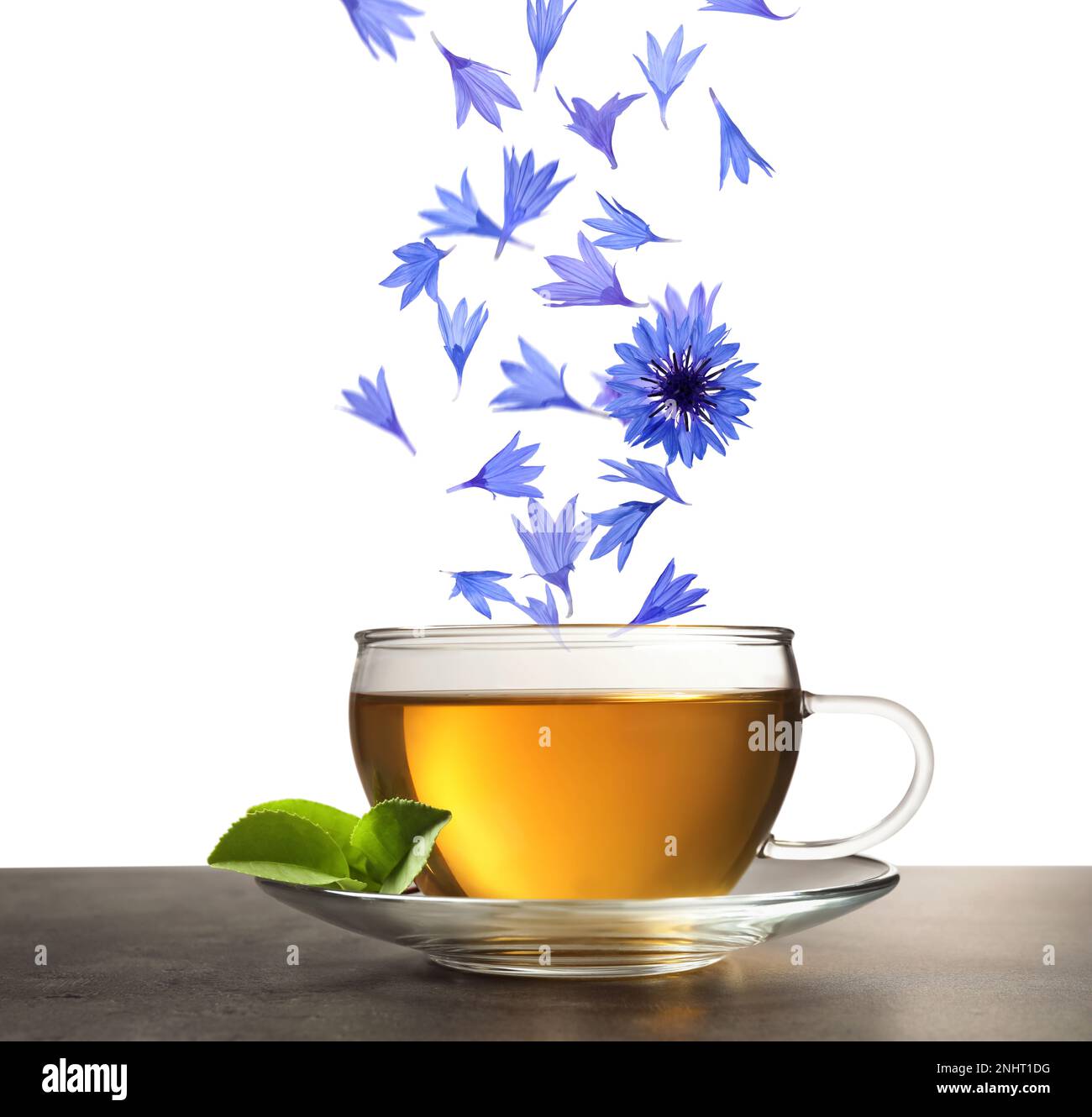 Beautiful tender blue cornflower petals falling into cup of tea on ...