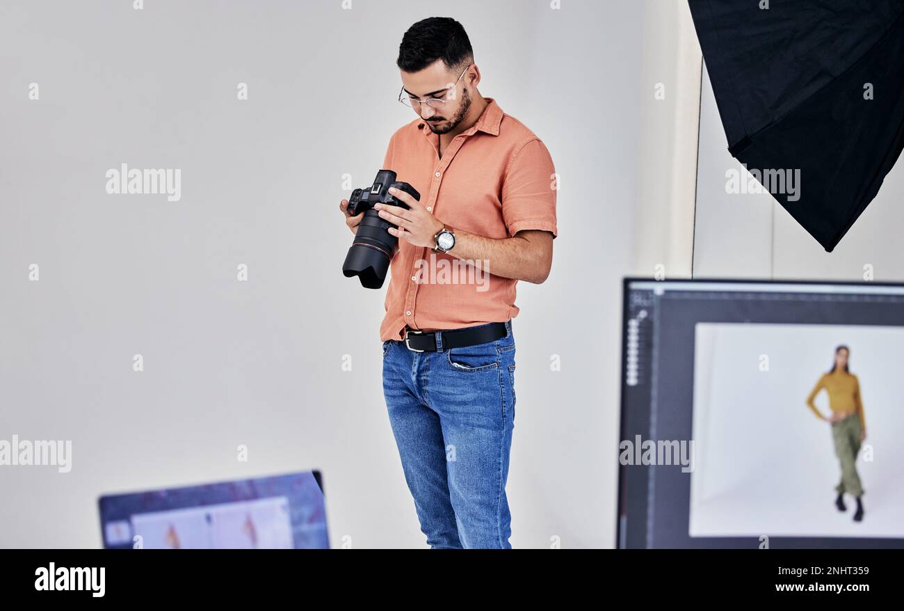 Serious, photographer and man on camera in studio for shoot, magazine ...
