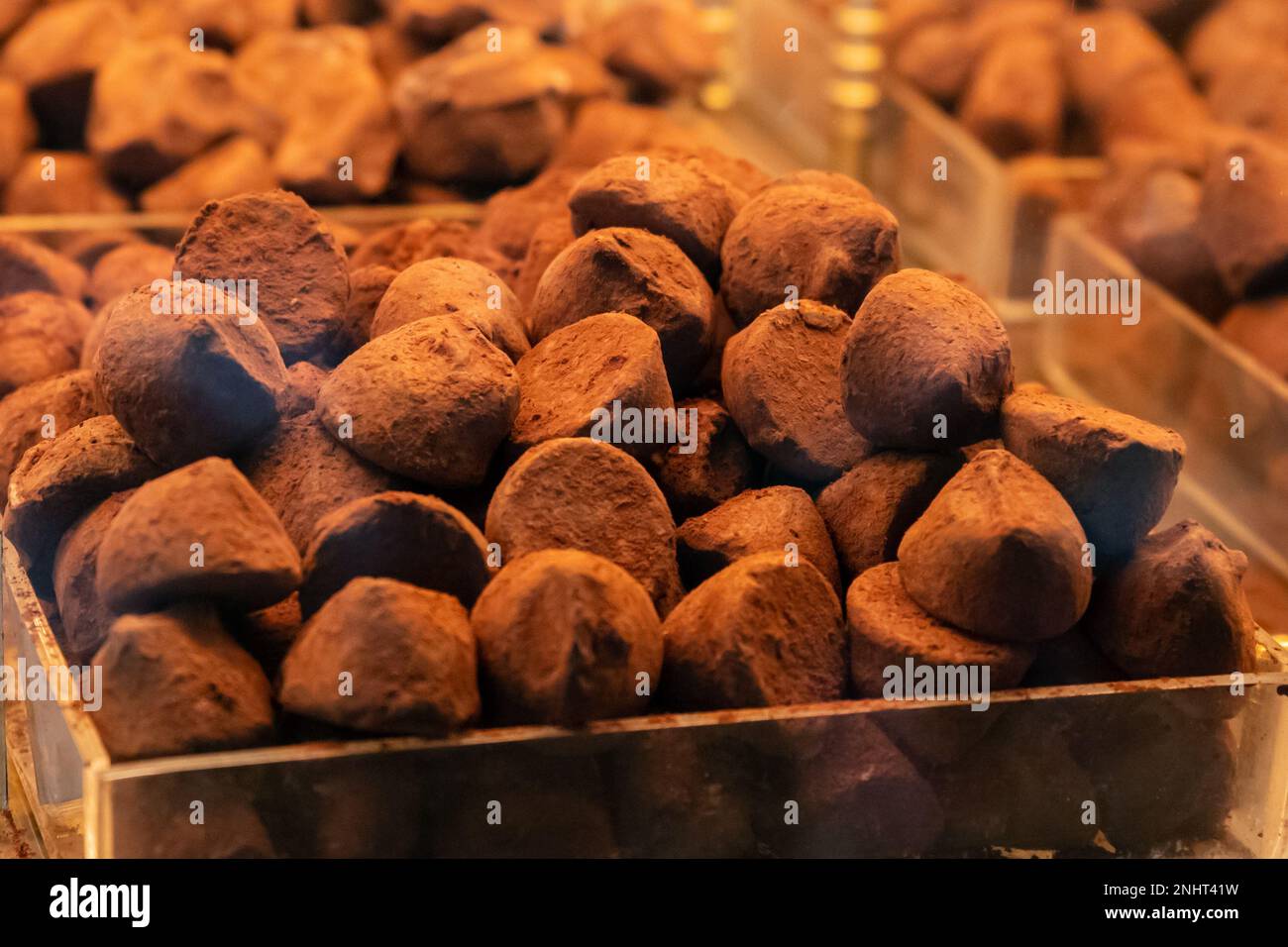 Chocolate truffles covered with cocoa a lot on shop window. Heap of ...