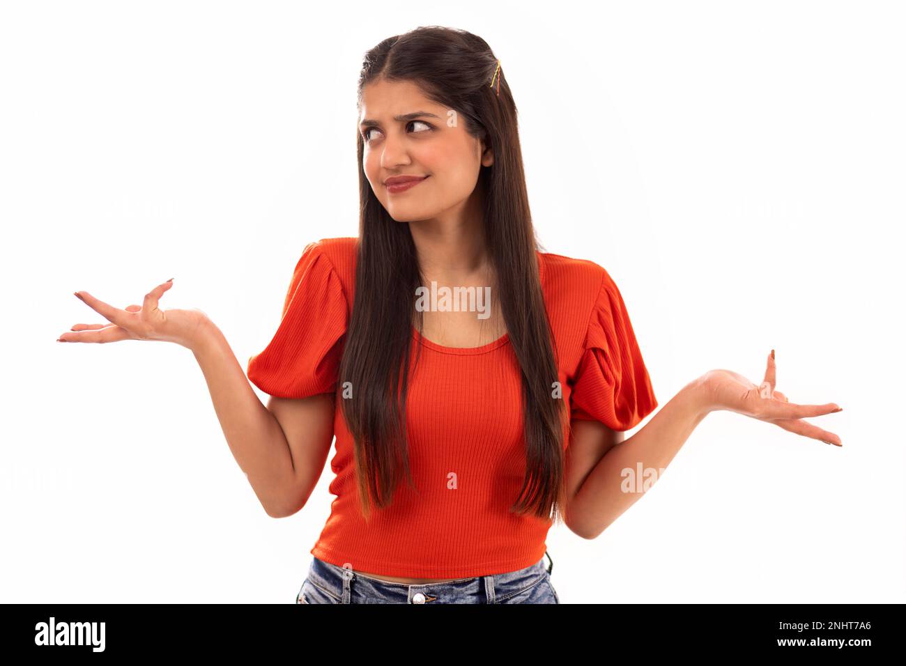 Portrait of beautiful woman shrugging against white background Stock ...