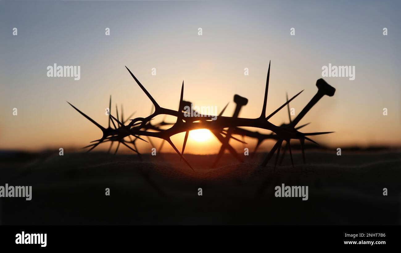 The cross, crown of thorns, nails and red sunset symbolizing the ...