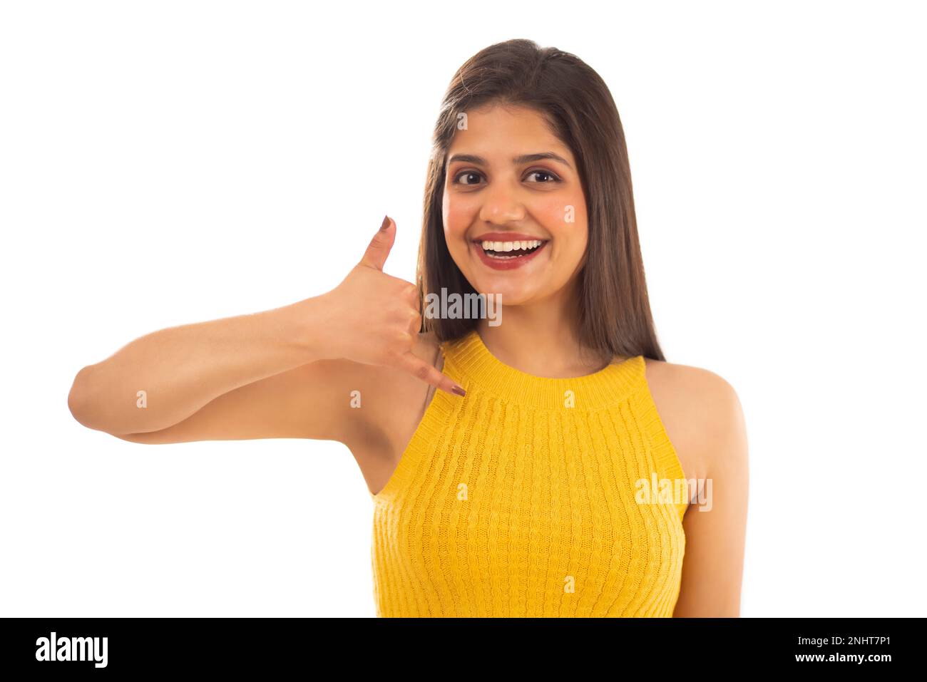 Portrait of beautiful showing calling gesture against white background ...