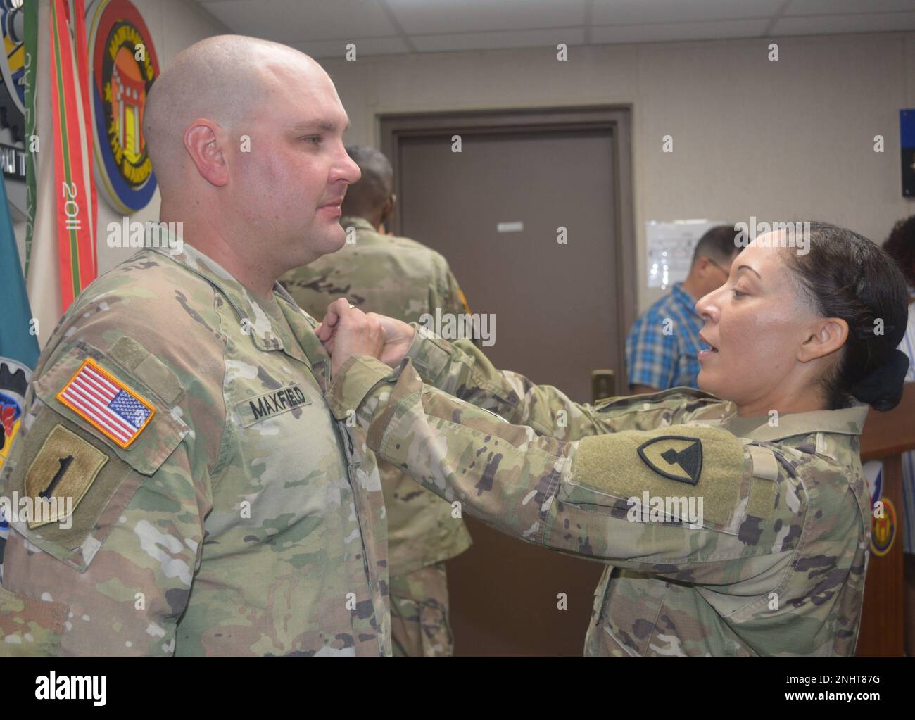 Col. Lisa Rennard, commander, 403rd Army Field Support Brigade, pins ...
