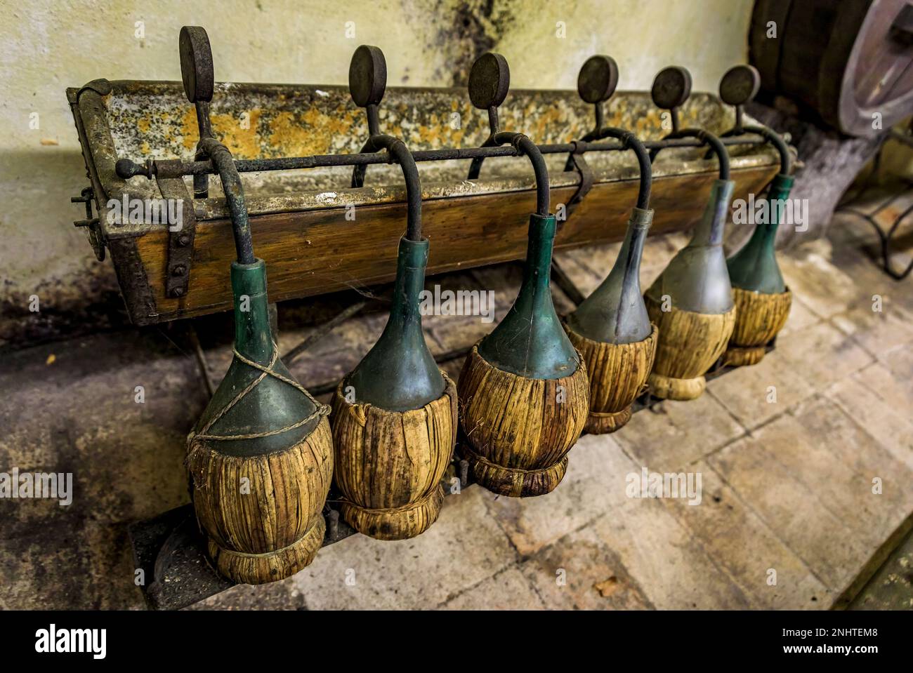 Old traditional fiasco green glass bottles with straw at a vineyard in ...