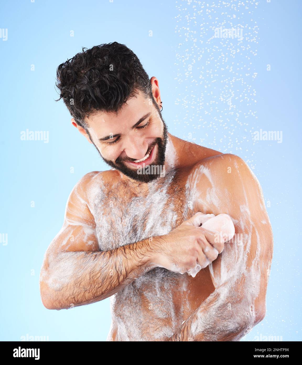 Soap, shower and man with water splash, smile and hygiene in studio for ...