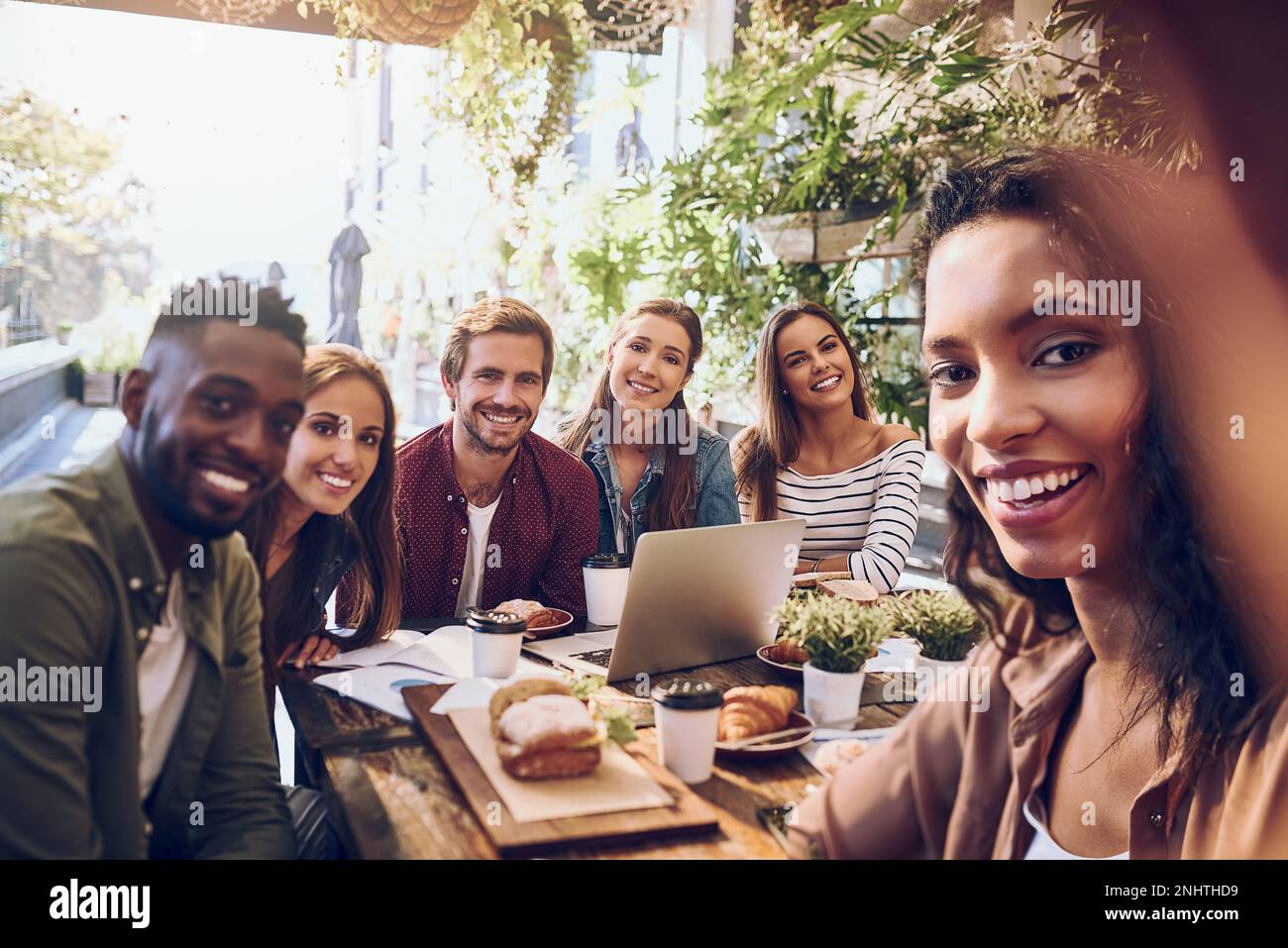Selfie on our lunch break. a woman taking a selfie with her colleagues ...