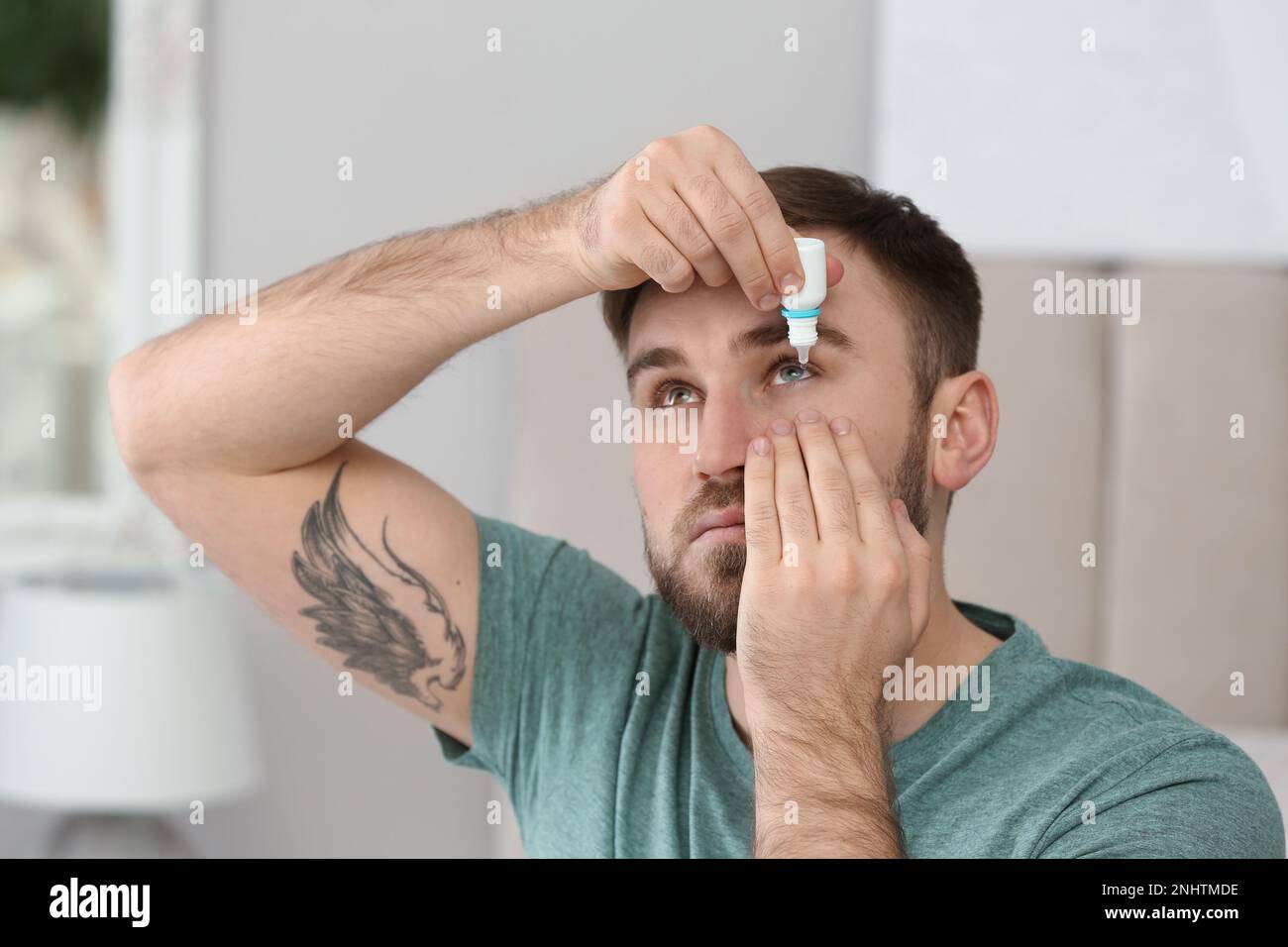 Man using eye drops hi-res stock photography and images - Alamy