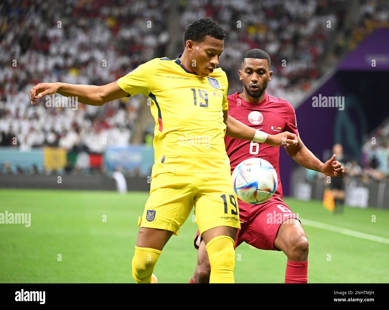 Qatar's ABDULAZIZ HATEM and Ecuador's Gonzalo PLATA struggle to hold a ball in the first half of ...