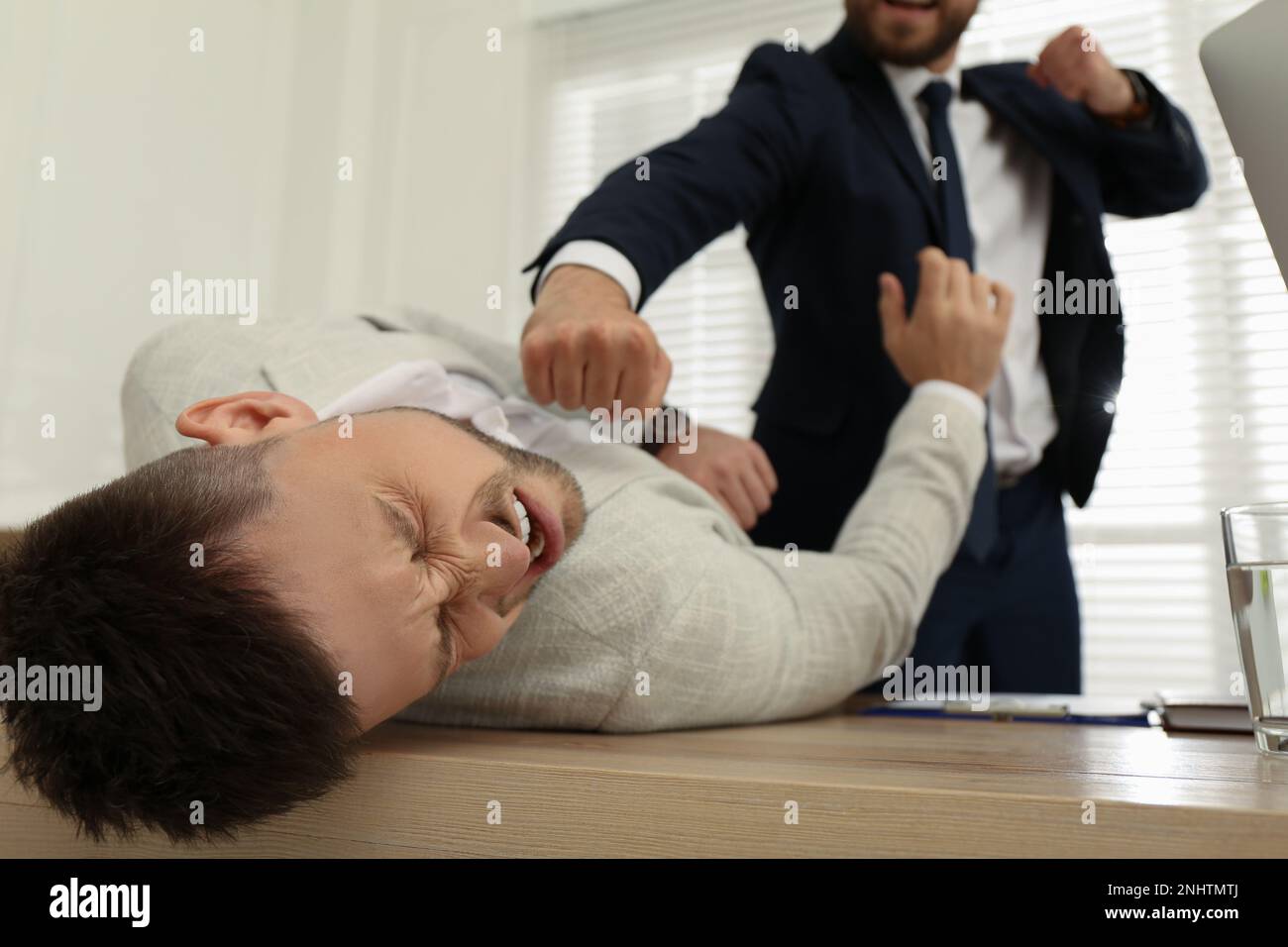 Emotional colleagues fighting in office. Workplace conflict Stock Photo ...