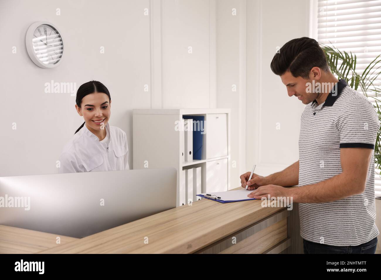 Nurse and patient at reception in hospital Stock Photo - Alamy