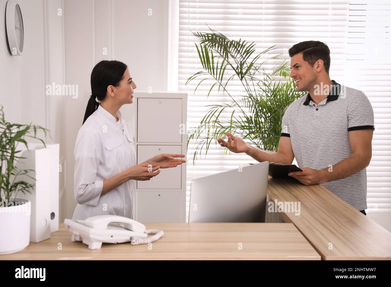 Nurse and patient at reception in hospital Stock Photo - Alamy