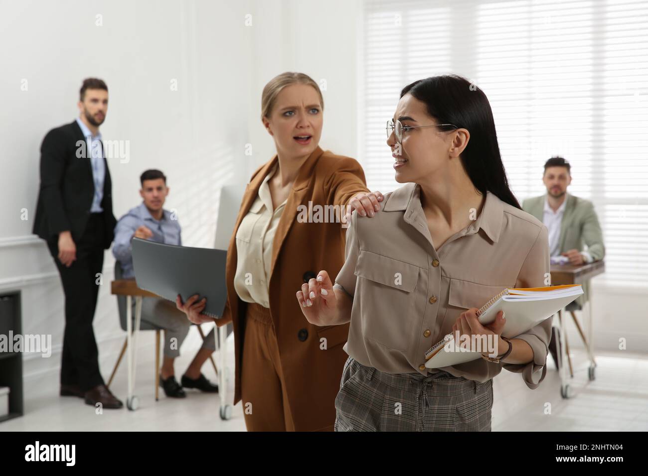 Emotional colleagues fighting in office. Workplace conflict Stock Photo ...