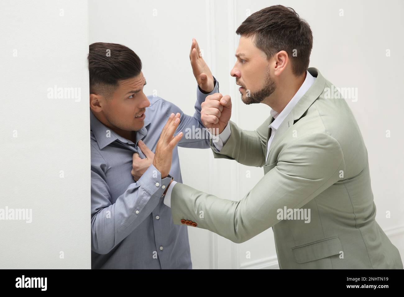 Emotional colleagues fighting in office. Workplace conflict Stock Photo ...