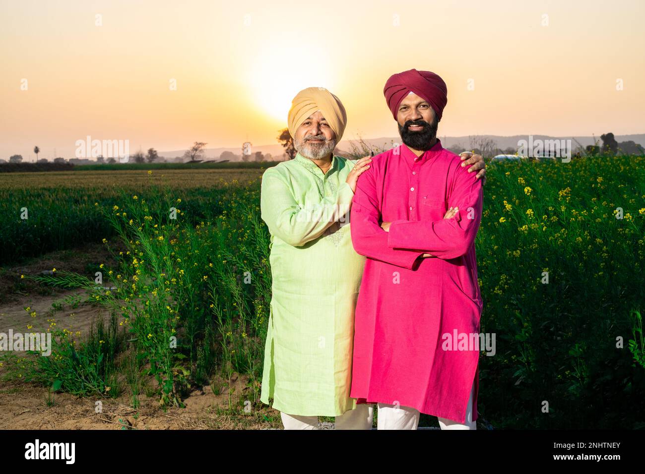 Portrait of happy punjabi srdar father and son wearing kurta and pagdi ...