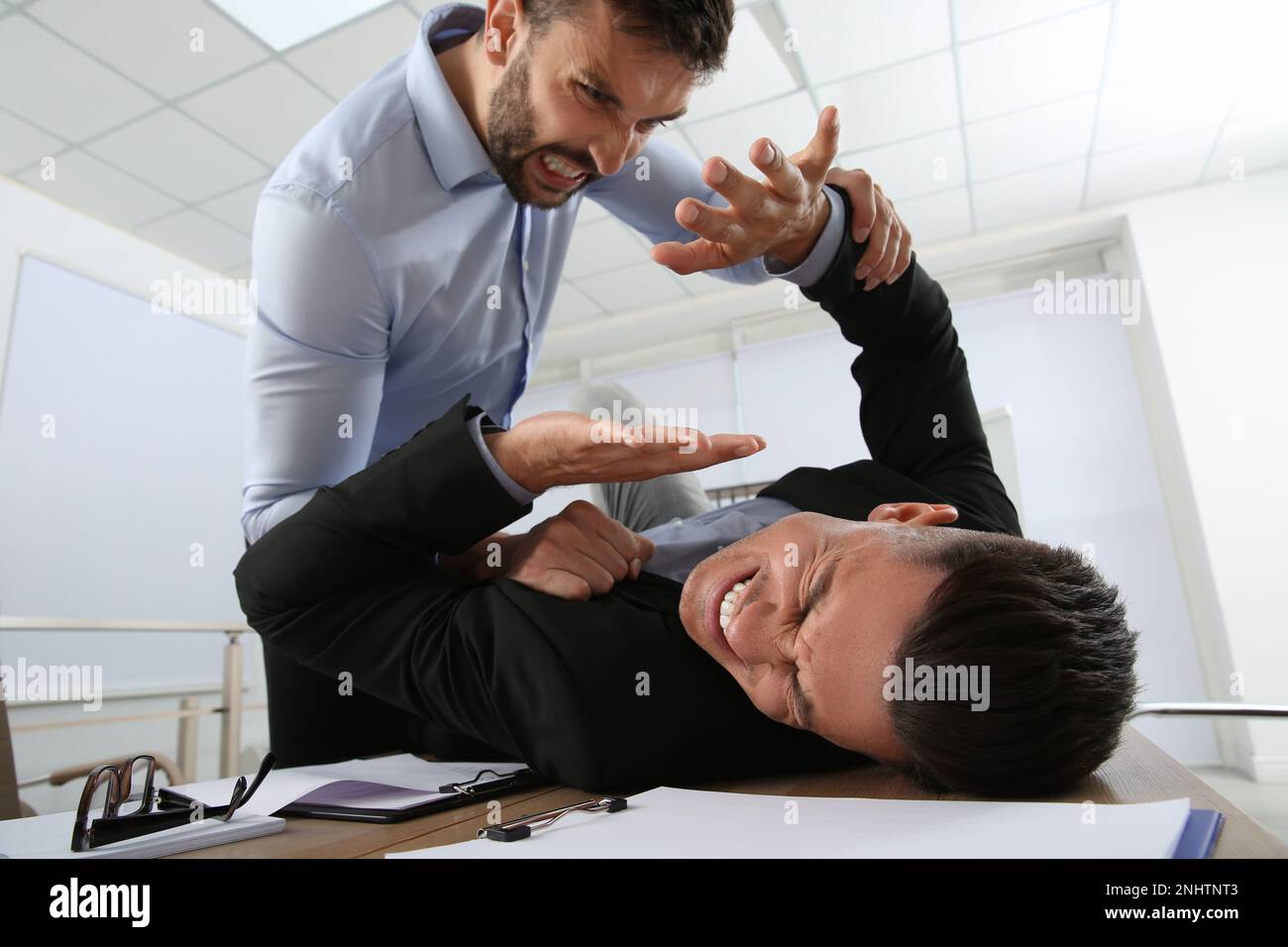 Emotional colleagues fighting in office. Workplace conflict Stock Photo ...