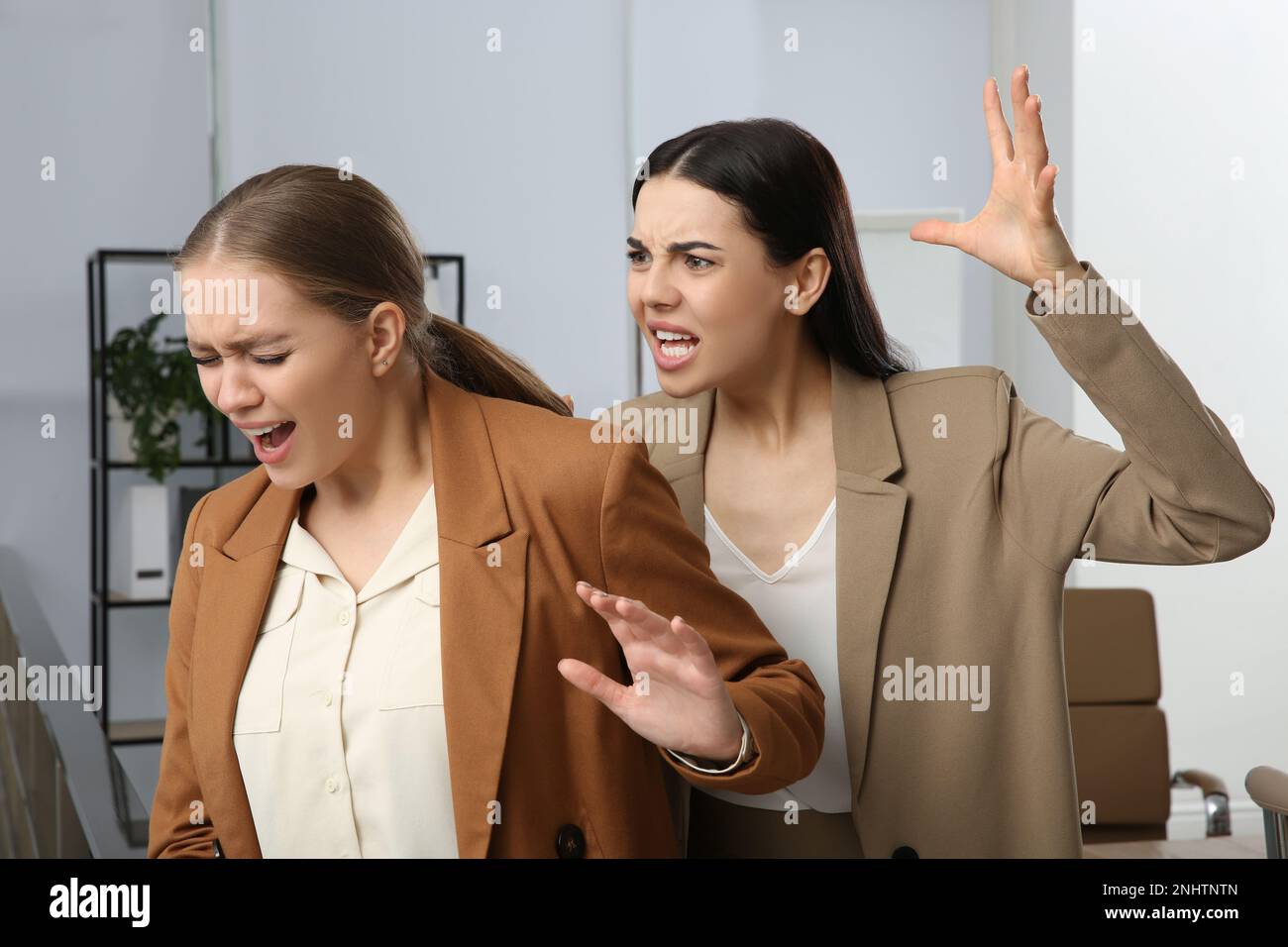 Emotional colleagues fighting in office. Workplace conflict Stock Photo ...