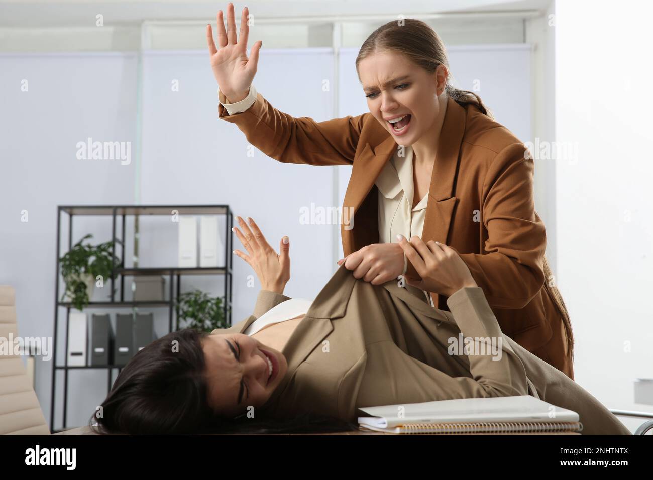 Emotional colleagues fighting in office. Workplace conflict Stock Photo ...
