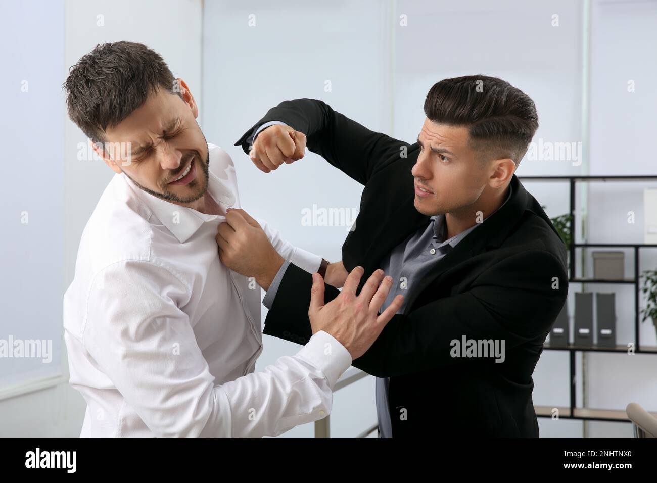 Emotional colleagues fighting in office. Workplace conflict Stock Photo ...