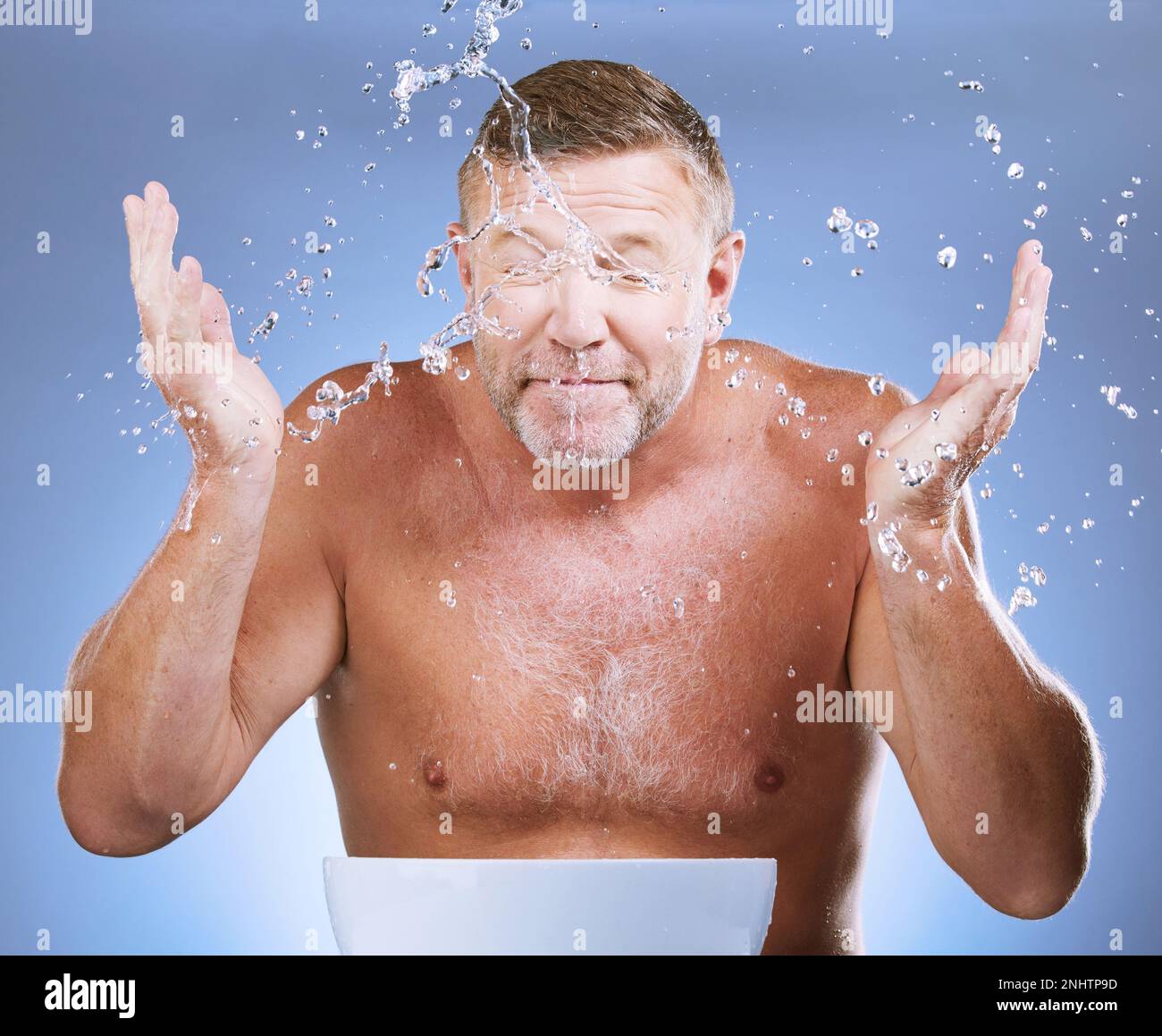 Man cleaning face, hands and water drop, hygiene and grooming with ...