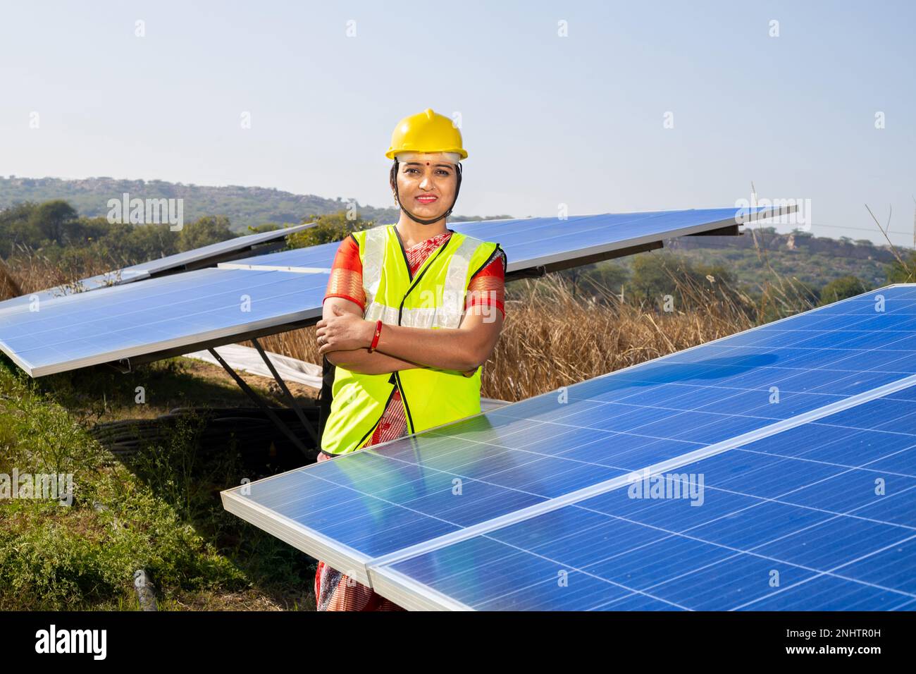 Portrait of Young indian woman technician wearing yellow hard hat ...